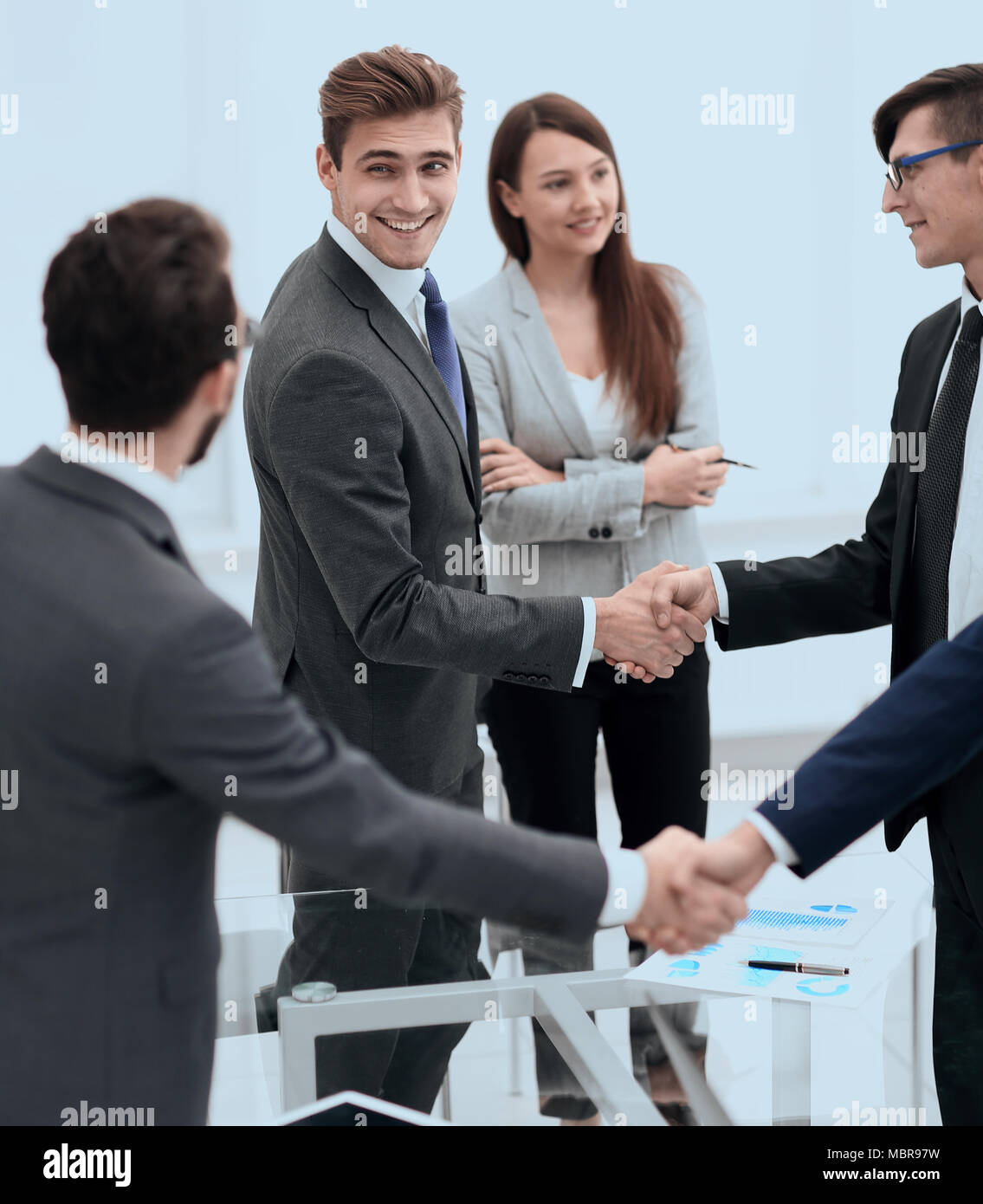 Happy smiling businessmen handshaking after signing contract Stock ...