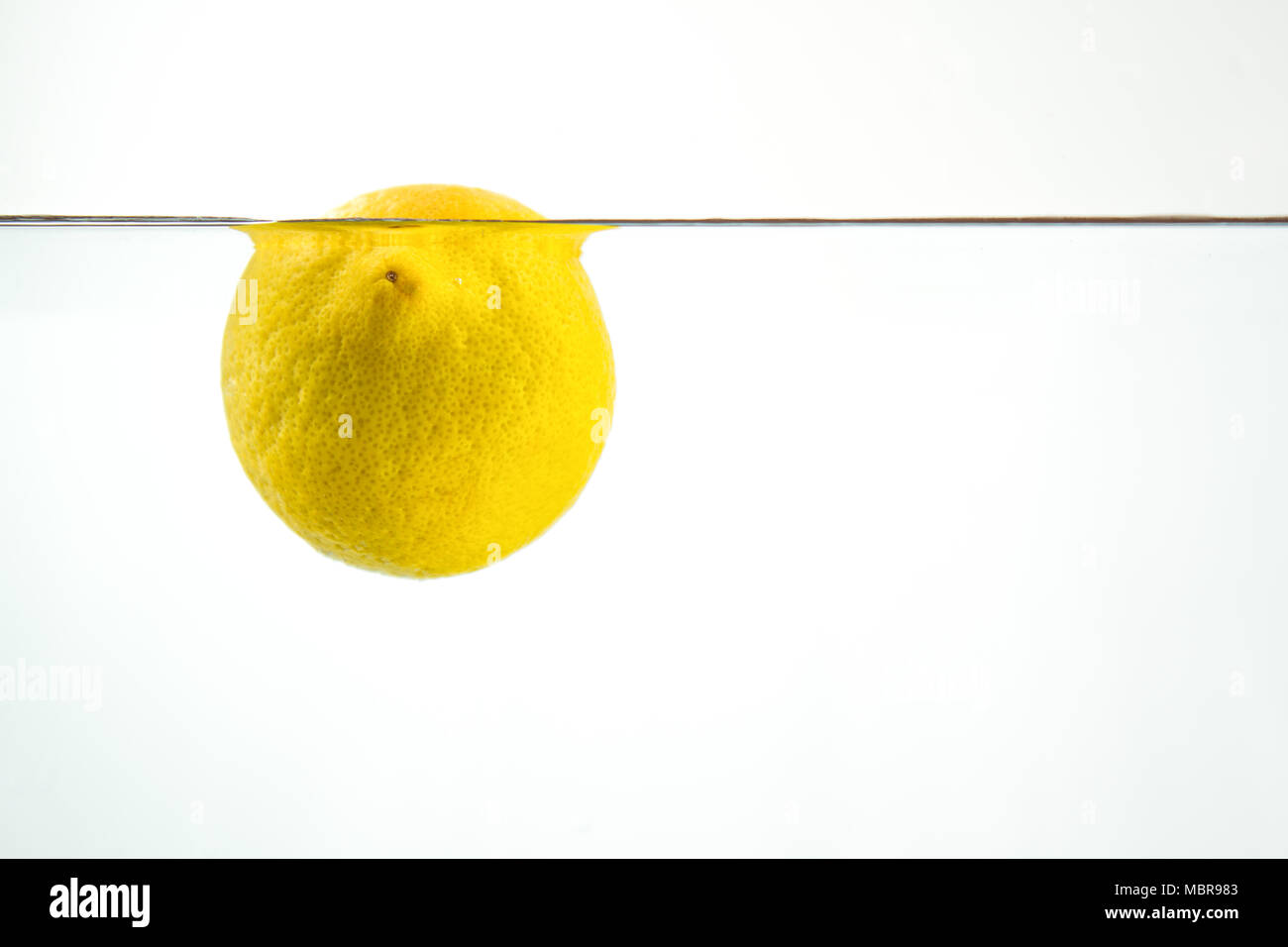 Yellow lemon floats in a water tank on a white background Stock Photo ...