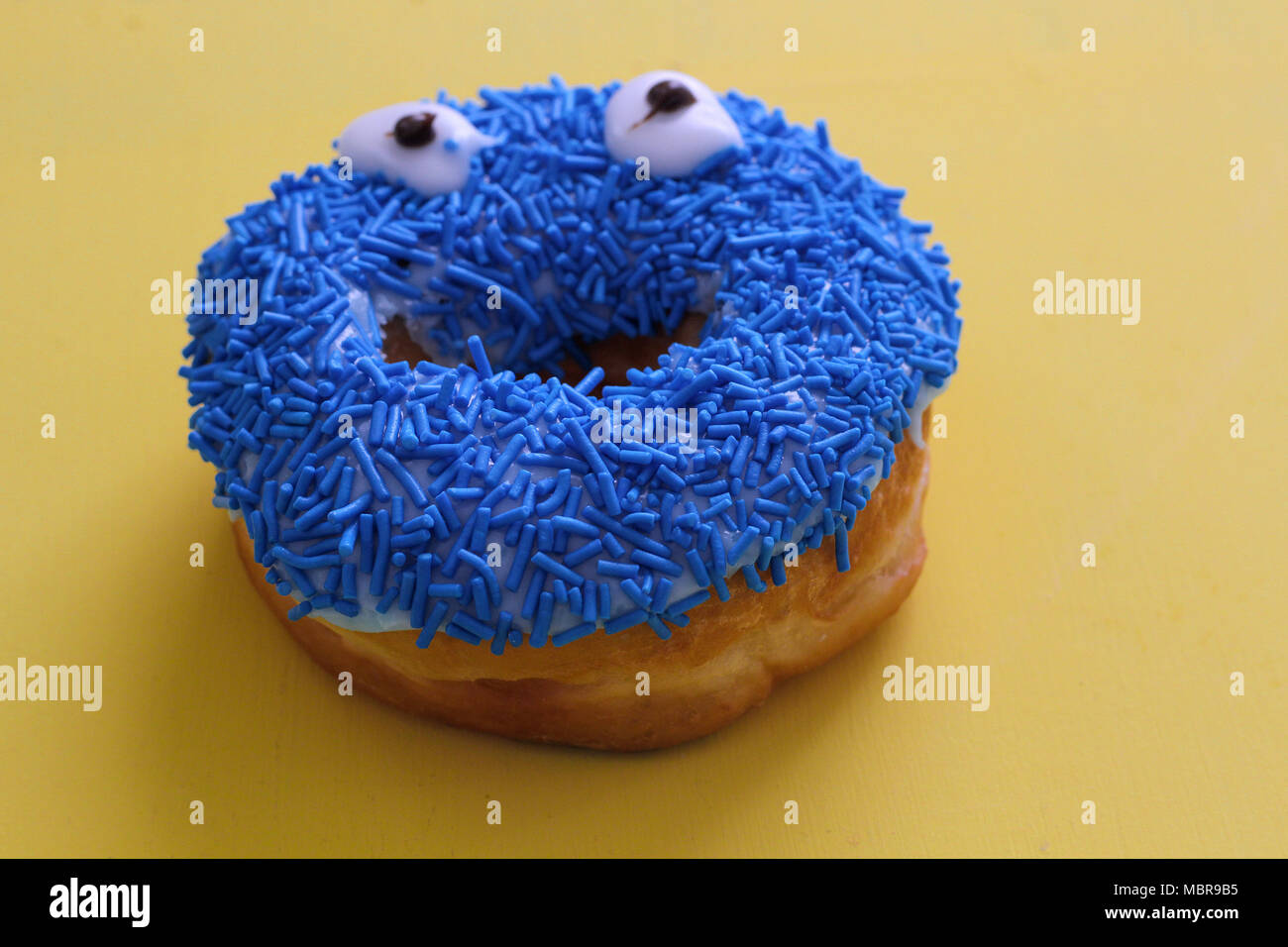 A blue sprinkled donut Stock Photo - Alamy