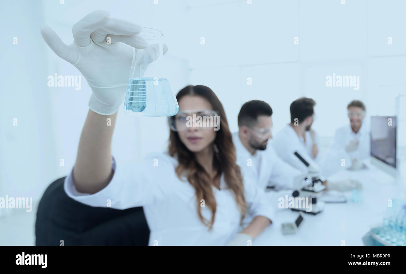 Mixed race scientist holding beaker hi-res stock photography and images - Alamy