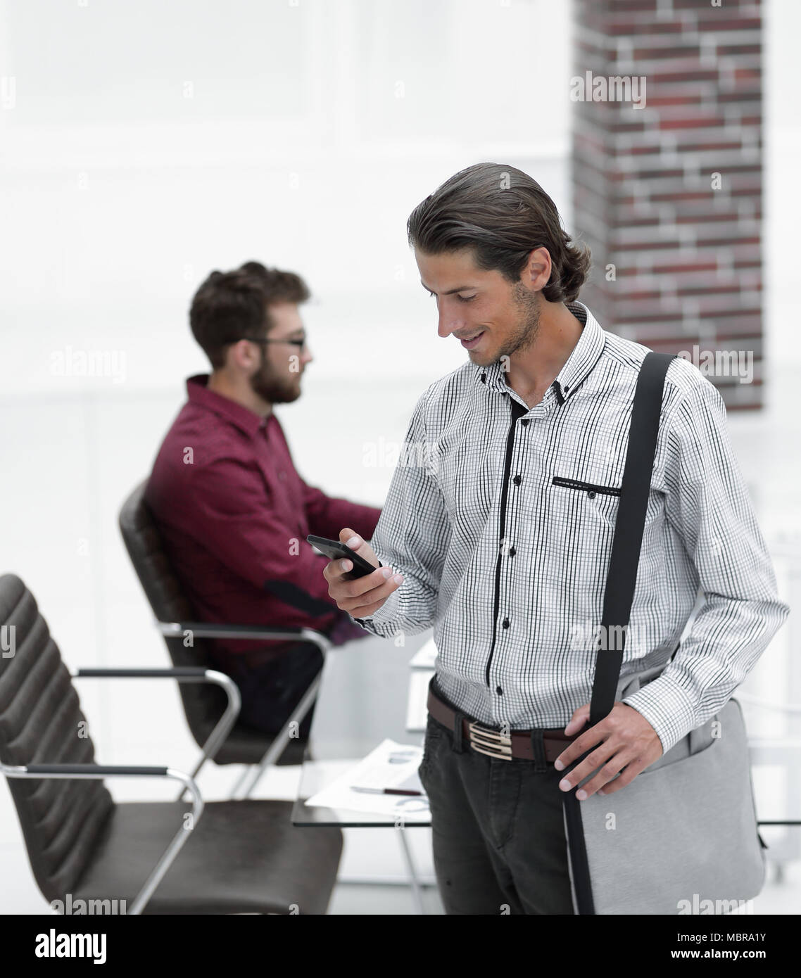 young employee standing in the office Stock Photo - Alamy