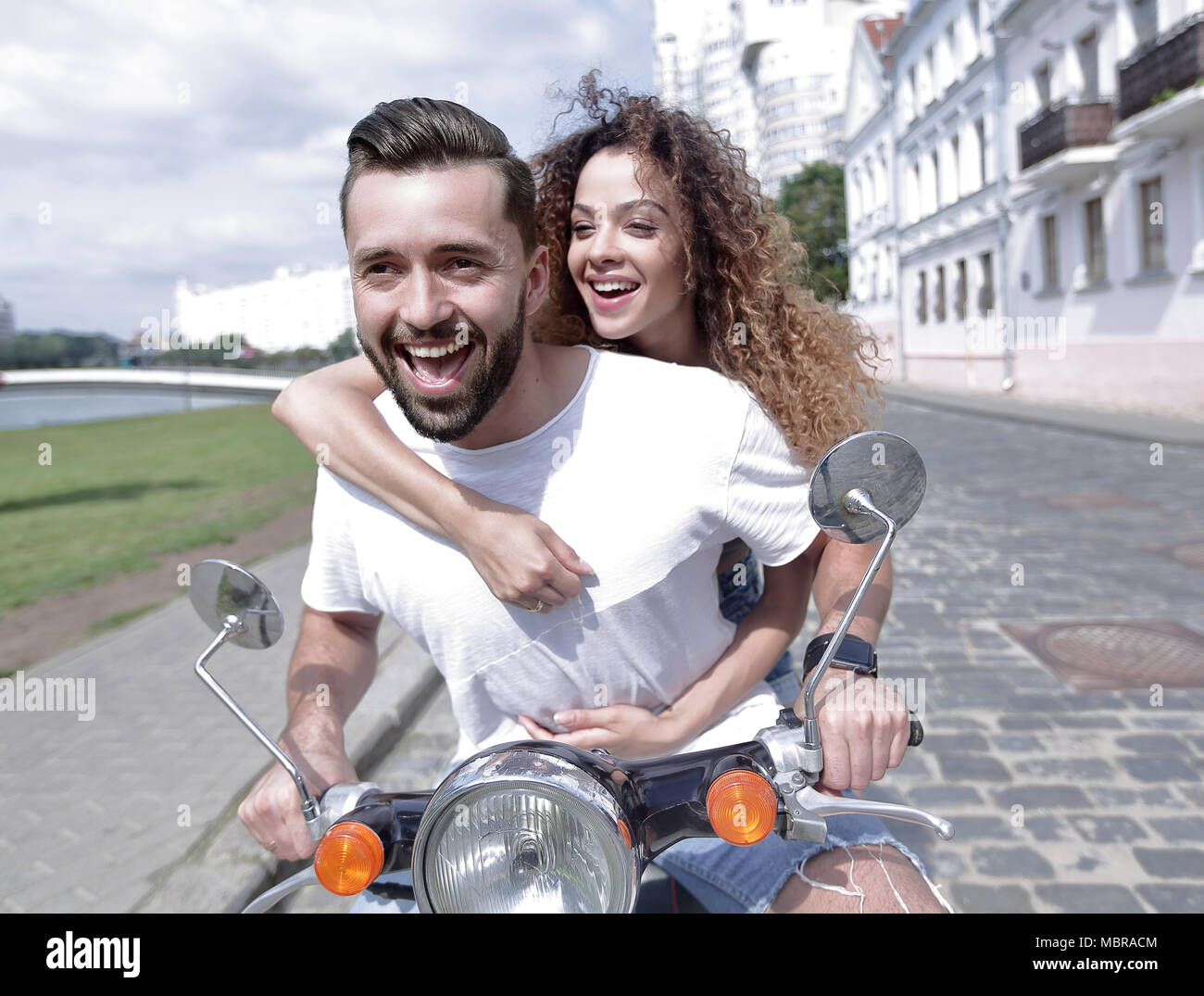 Happy cheerful couple riding vintage scooter outdoors Stock Photo - Alamy