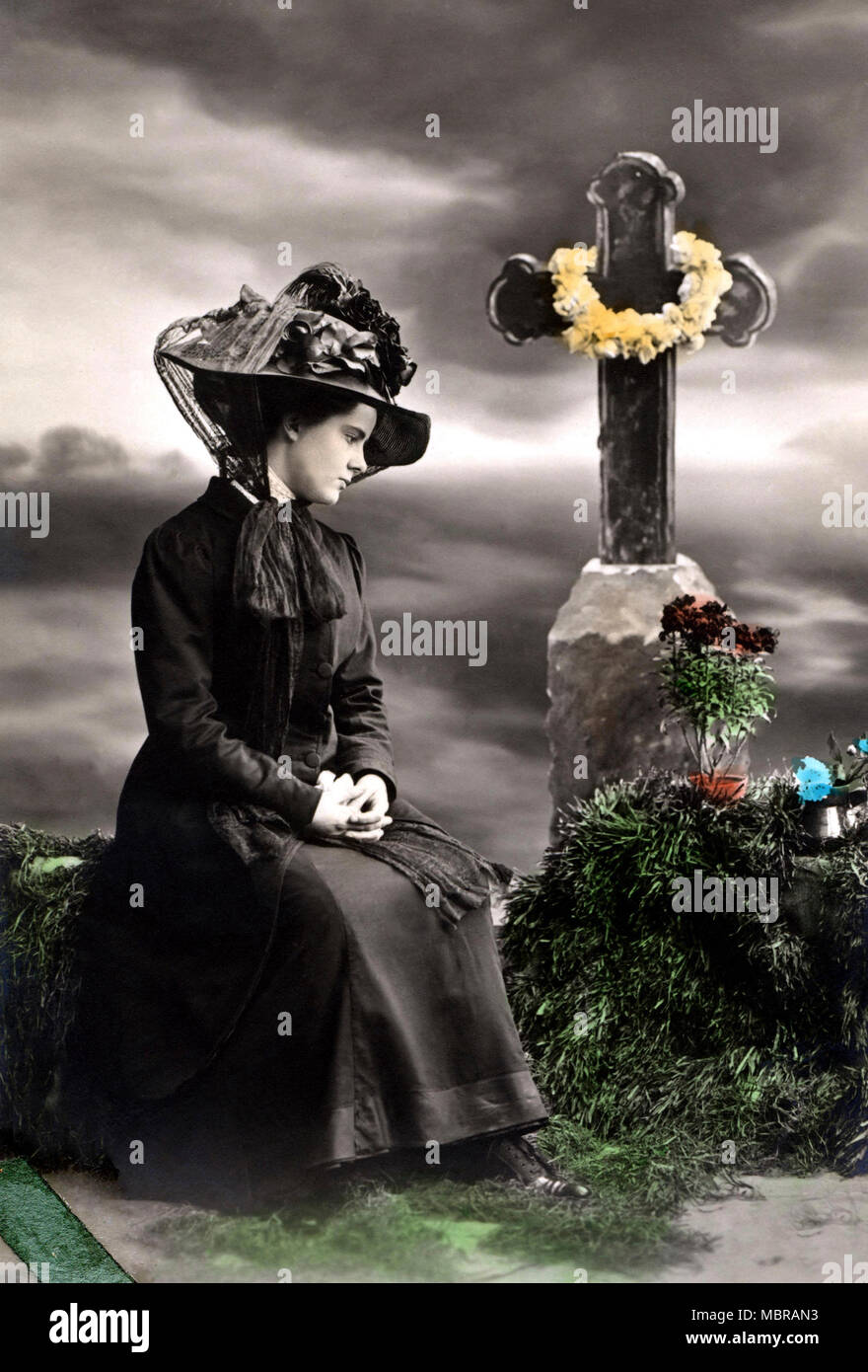Widow mourns in front of a grave on the cemetery, 1910s, Germany Stock ...