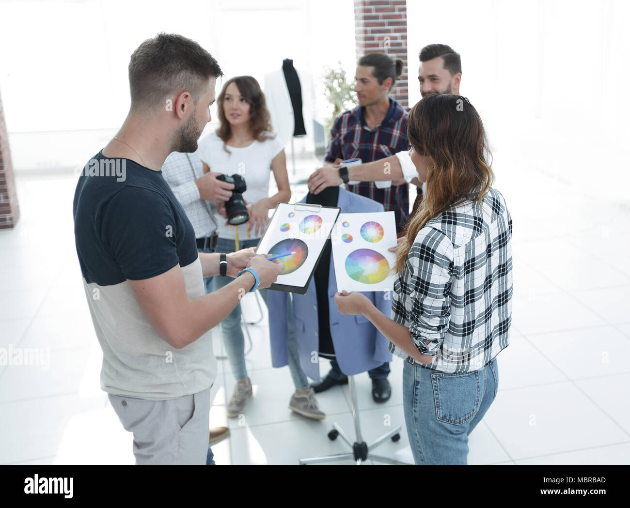 fashion designers discussing color palette Stock Photo - Alamy