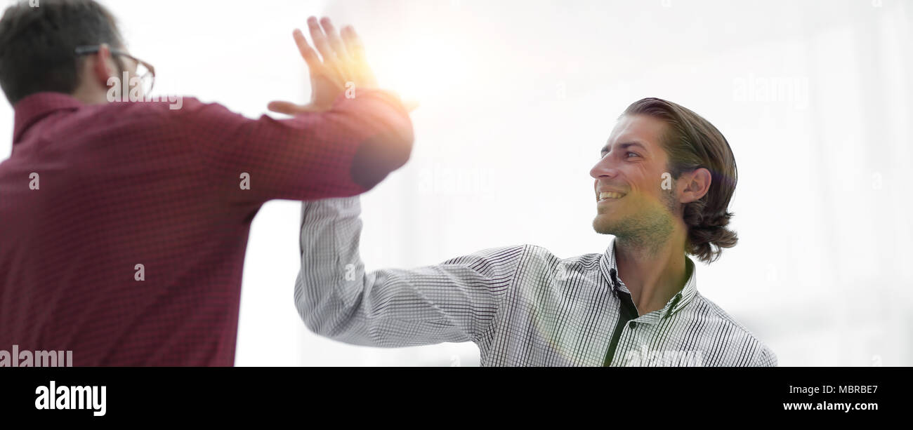 two business men giving each other a high five Stock Photo - Alamy