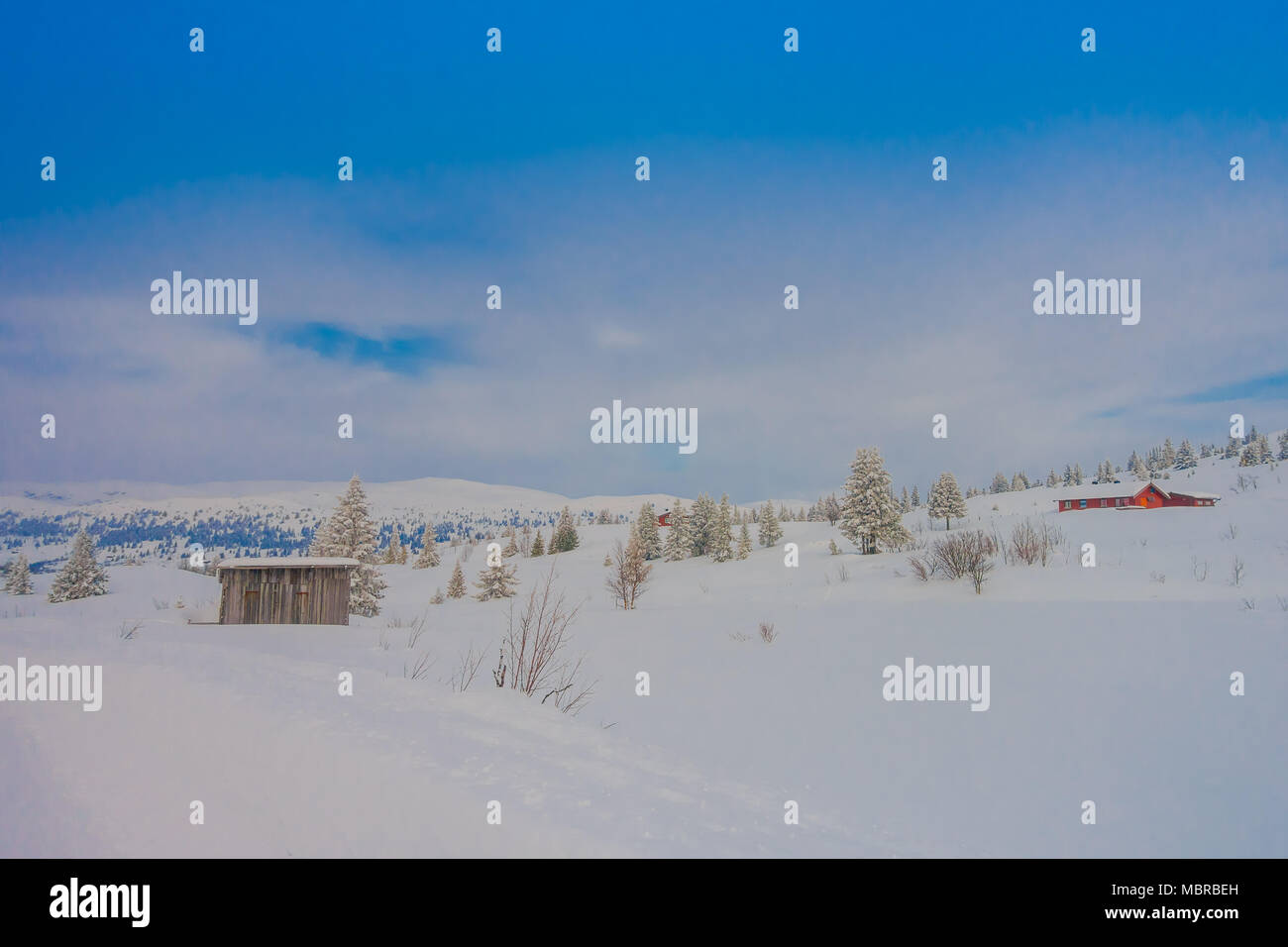 Outdoor view of old lonely wooden house covered with heavy snow and ...