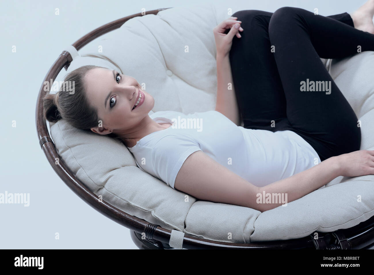 tired woman resting in an easy chair made of rattan Stock Photo - Alamy