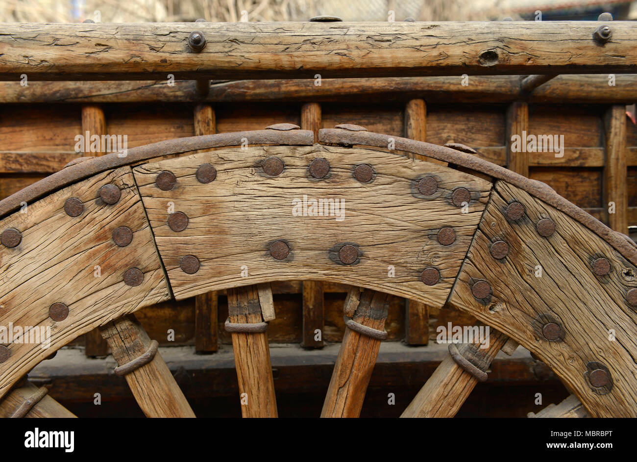Wheel with iron tyre of a replica traditional horse-drawn wooden cart ...