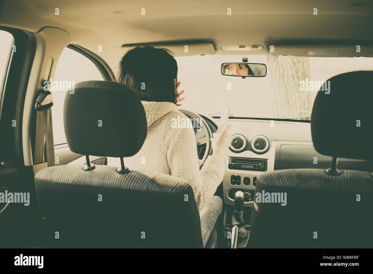 Young woman driving a car shocked about to have traffic accident. Woman ...