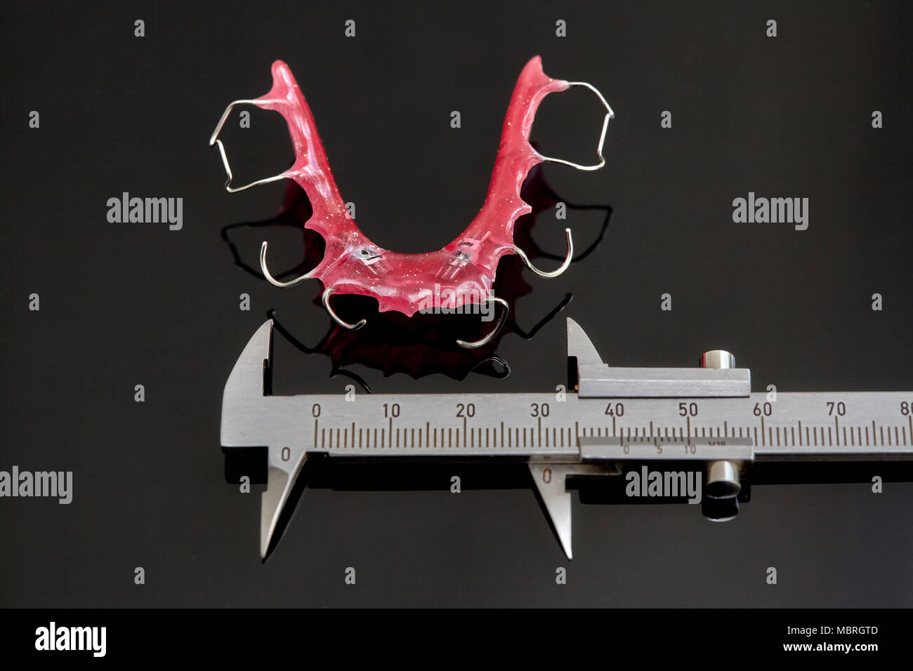 Colorful dental braces or retainers for teeth on black glass background ...