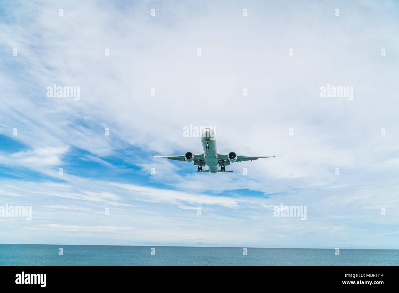 Airplane aircraft flying, landing in the good weather at blue cloudy ...