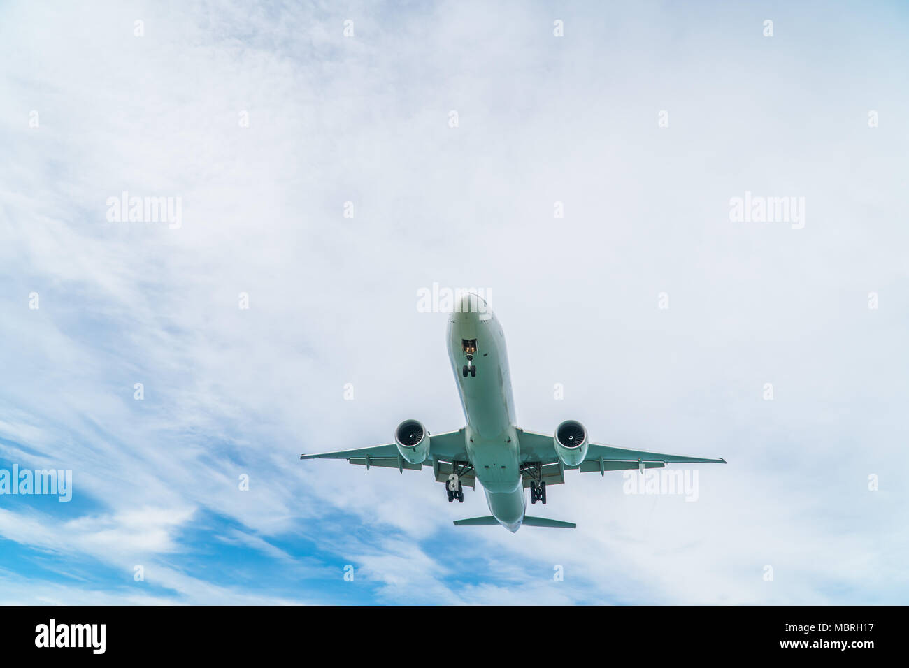 Airplane aircraft flying, landing in the good weather at blue cloudy ...