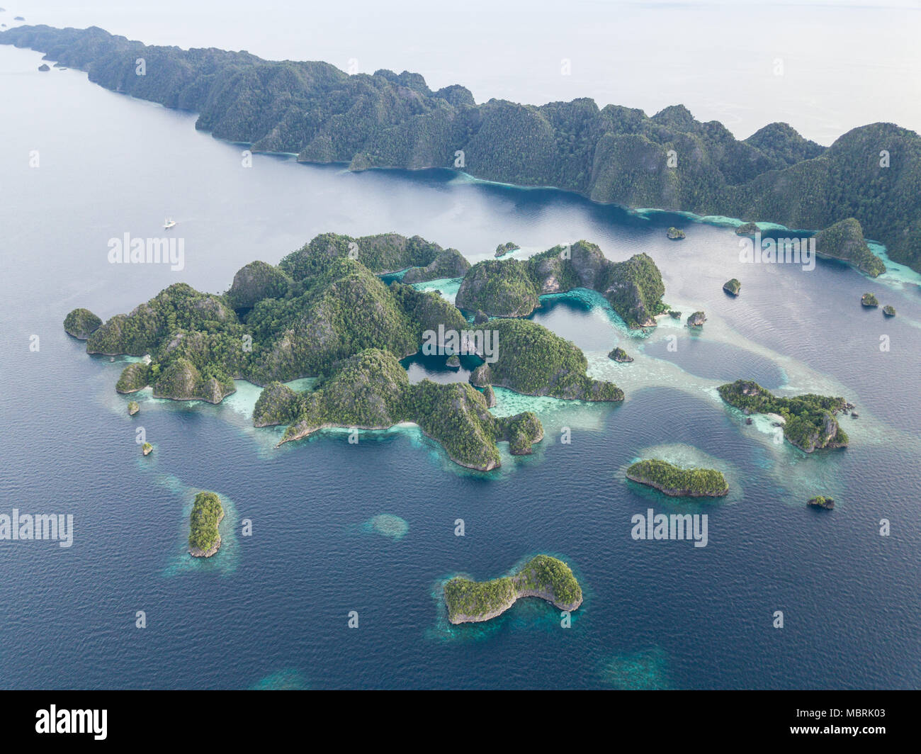 Beautiful limestone islands rise from the calm seas of Raja Ampat ...