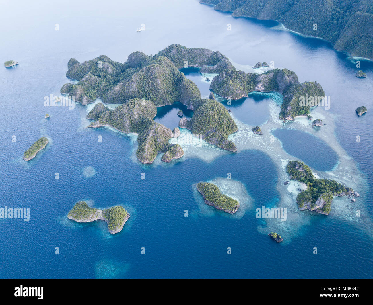 Beautiful limestone islands rise from the calm seas of Raja Ampat ...