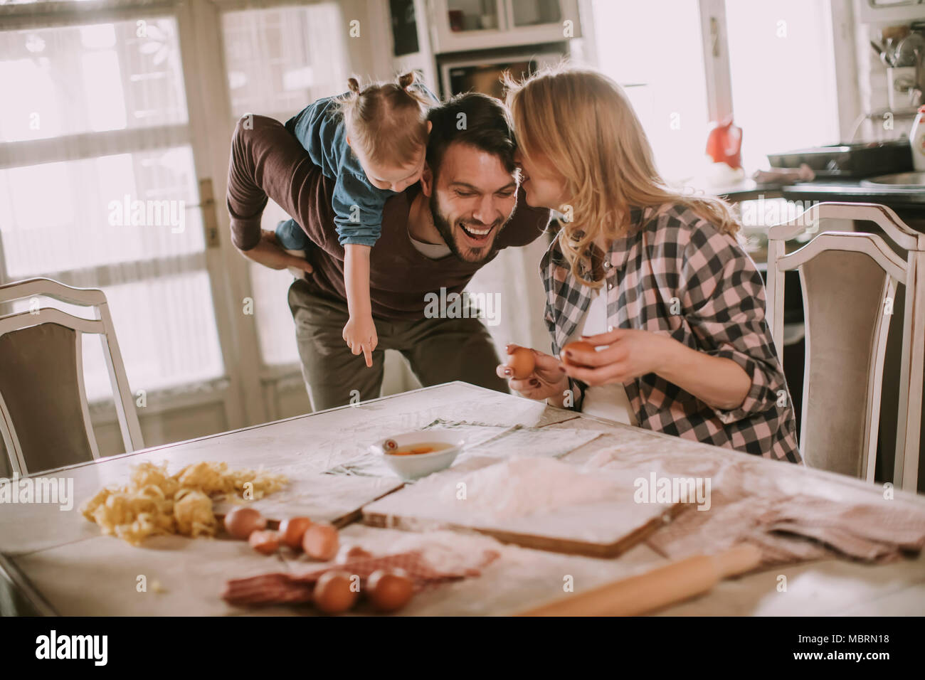 Happy family making pasta and having fun in the kitchen at home Stock ...
