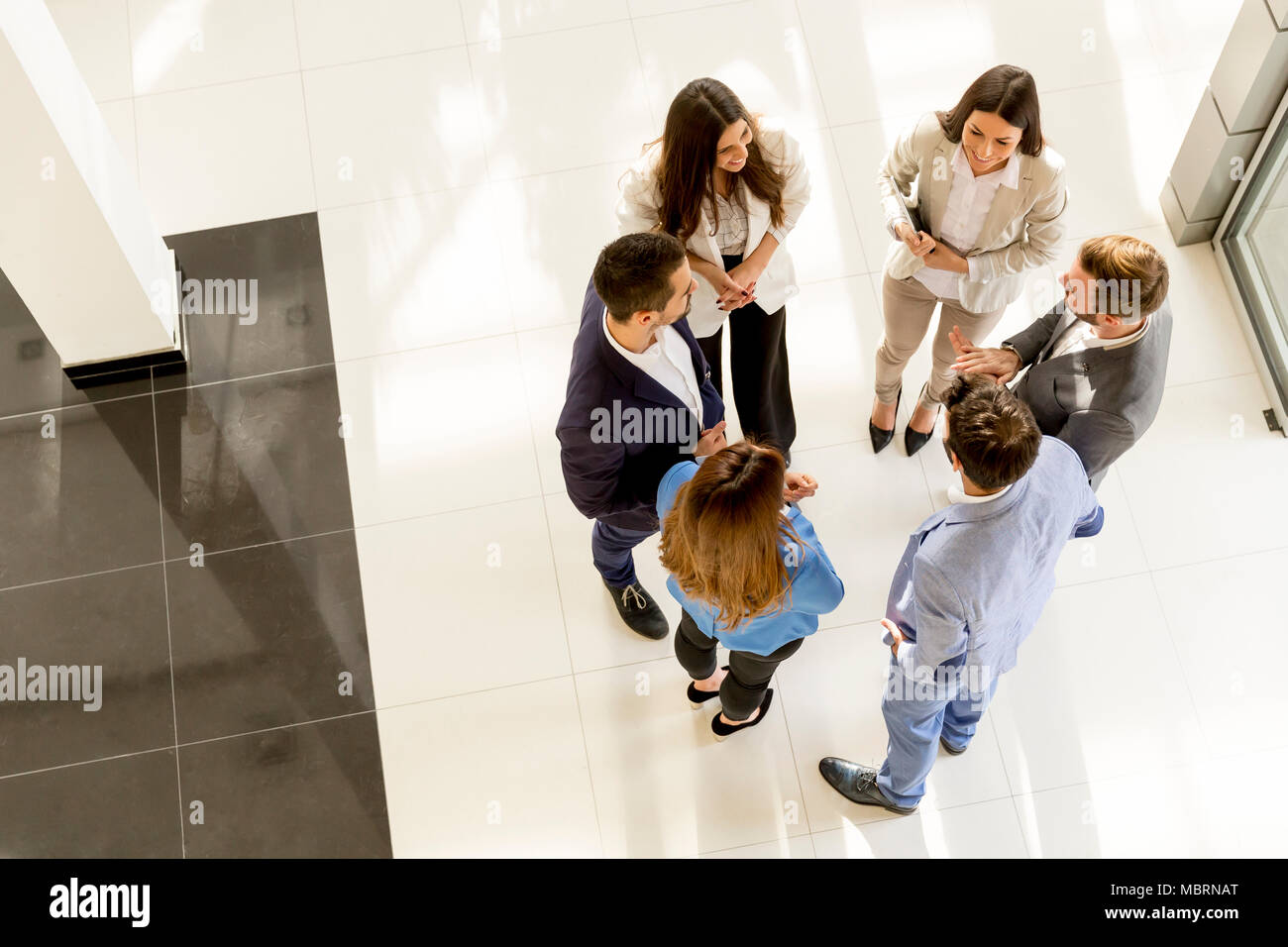 Overhead view of people having business meeting Stock Photo - Alamy