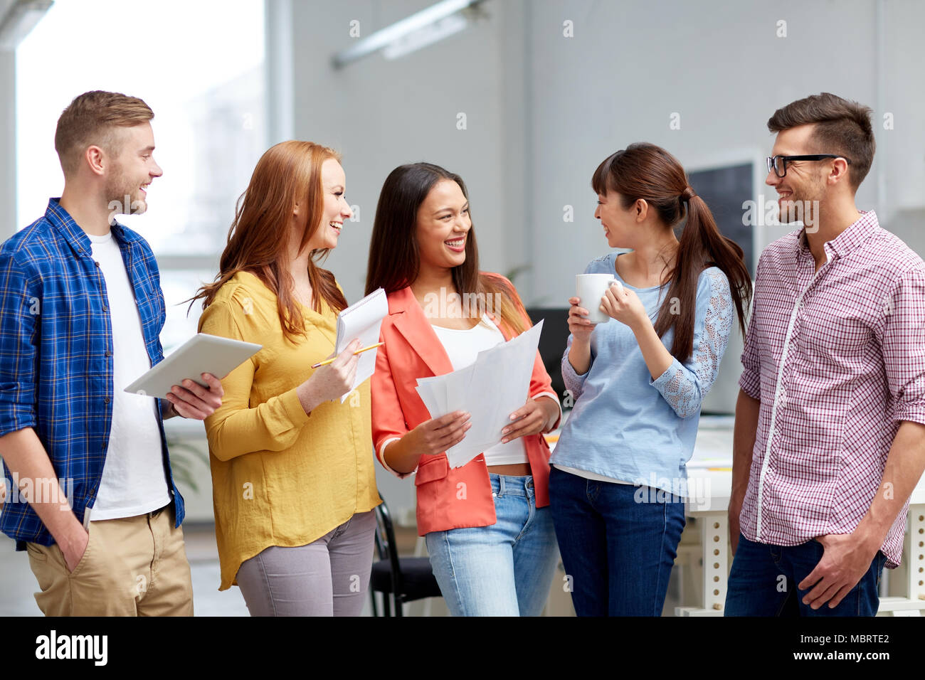 Happy creative team papers hi-res stock photography and images - Alamy
