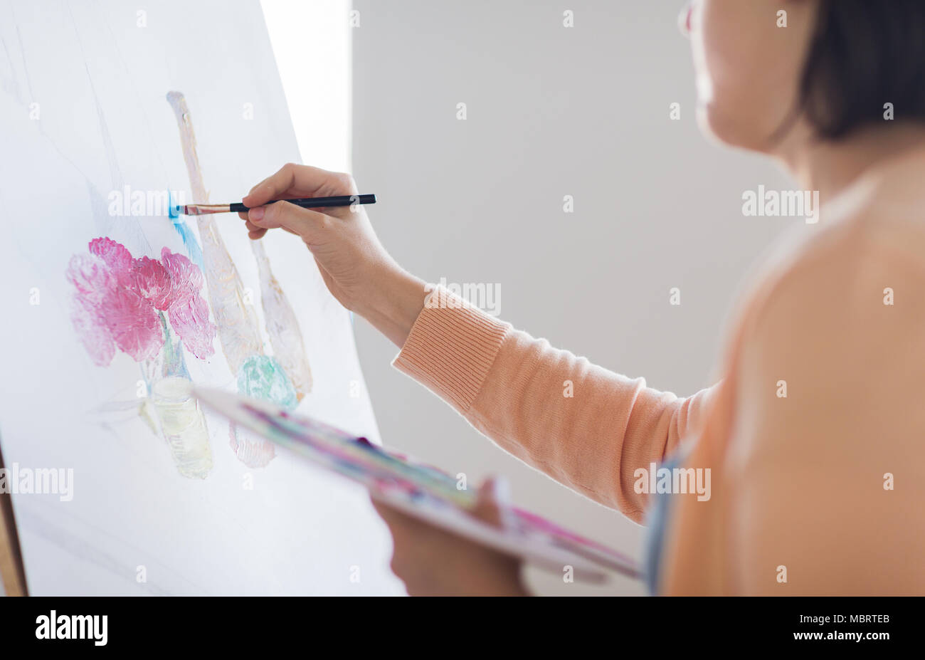 artist with palette and brush painting at studio Stock Photo - Alamy