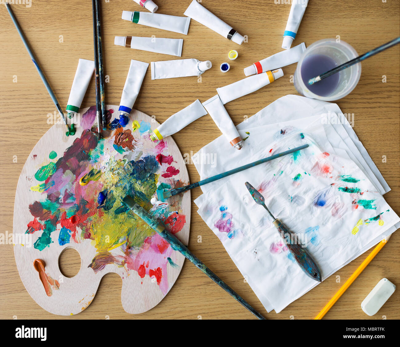 palette knife, brushes and paint tubes on table Stock Photo - Alamy