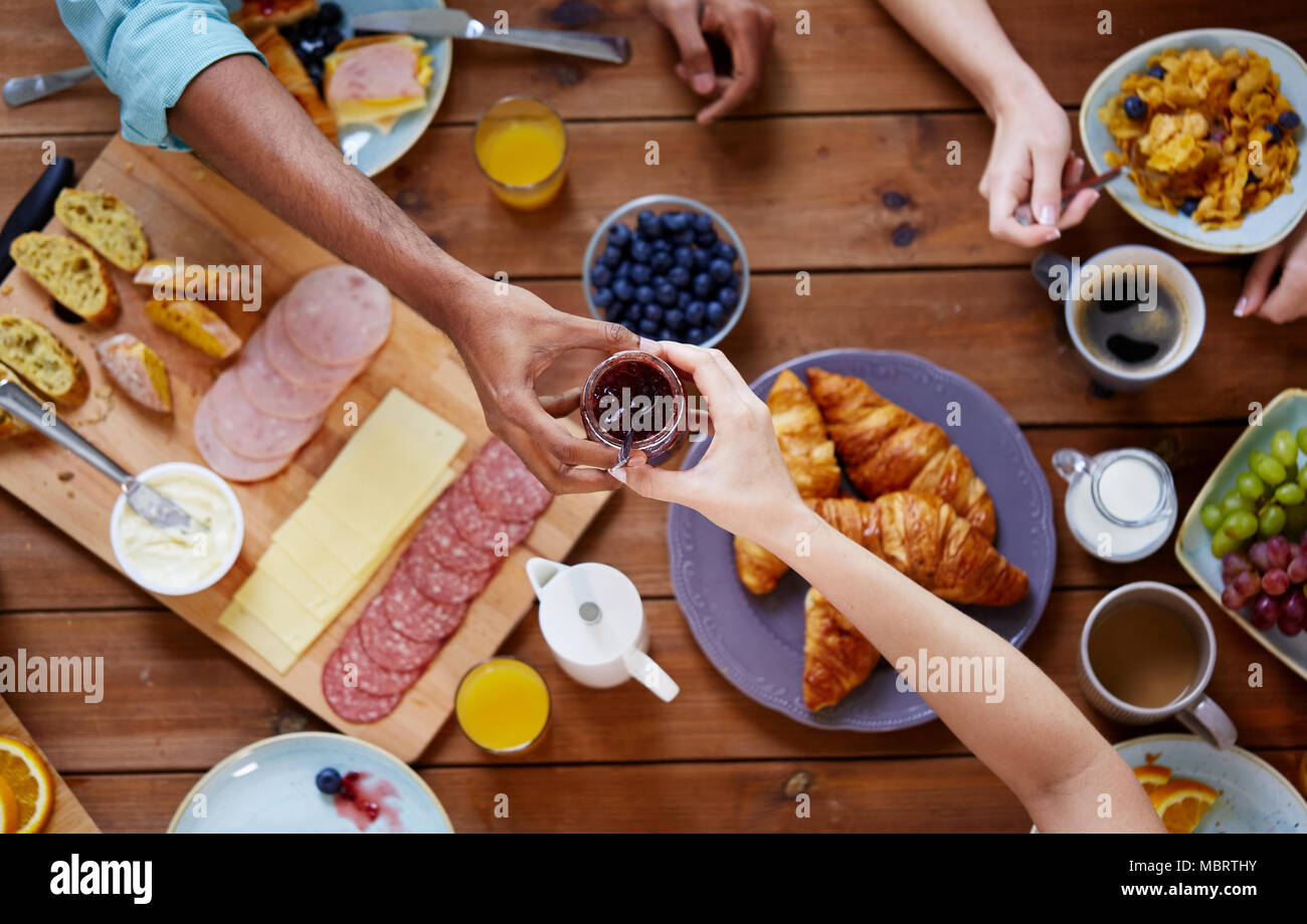 people having breakfast at table with food Stock Photo - Alamy