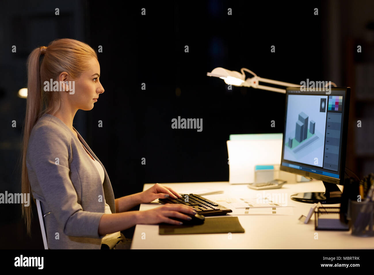 graphic designer with computer at night office Stock Photo - Alamy