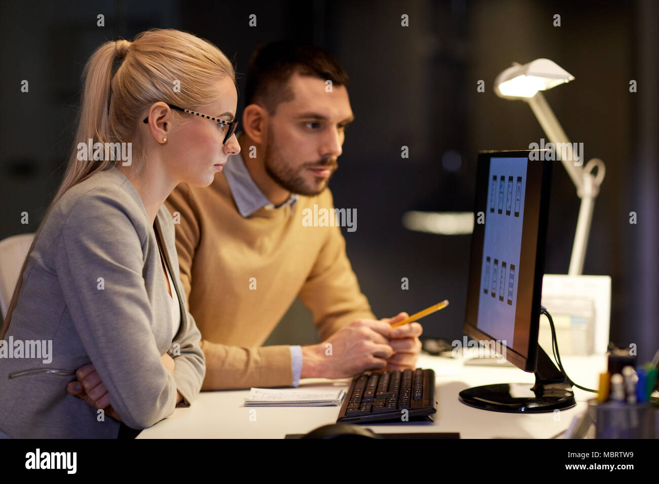 business team with computer working late at office Stock Photo - Alamy