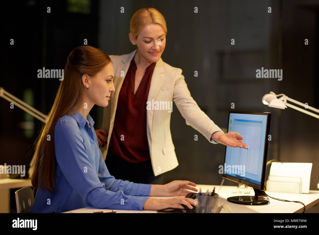 businesswomen with computer working late at office Stock Photo - Alamy