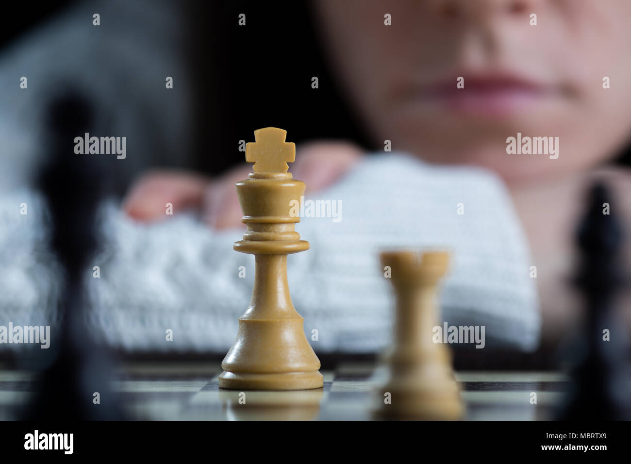 Serious Woman Playing Chess Watching the Chessboard Stock Photo - Alamy