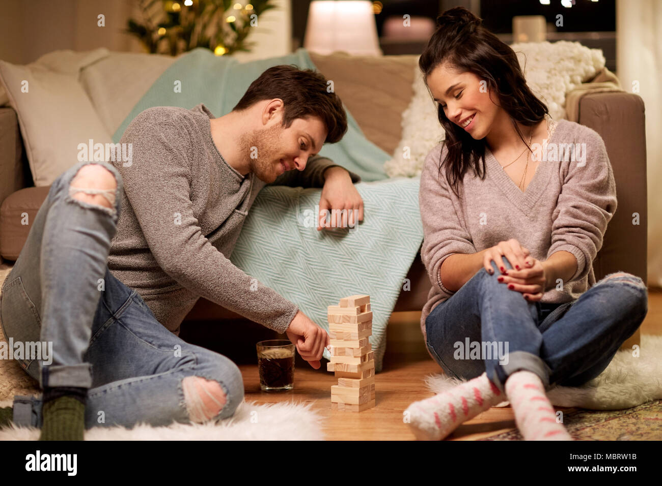 happy couple playing block-stacking game at home Stock Photo - Alamy