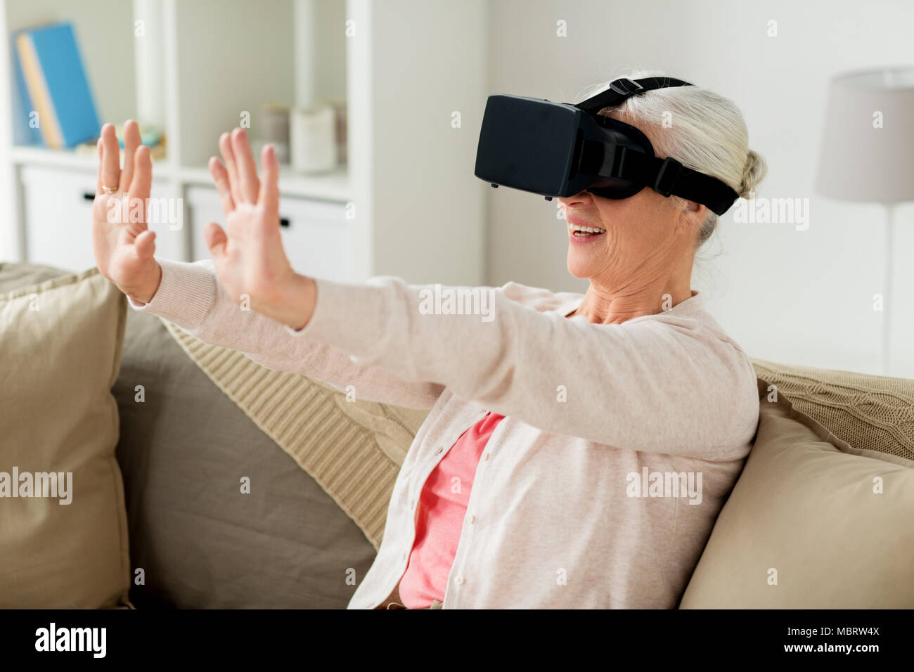 old woman in virtual reality headset or 3d glasses Stock Photo - Alamy