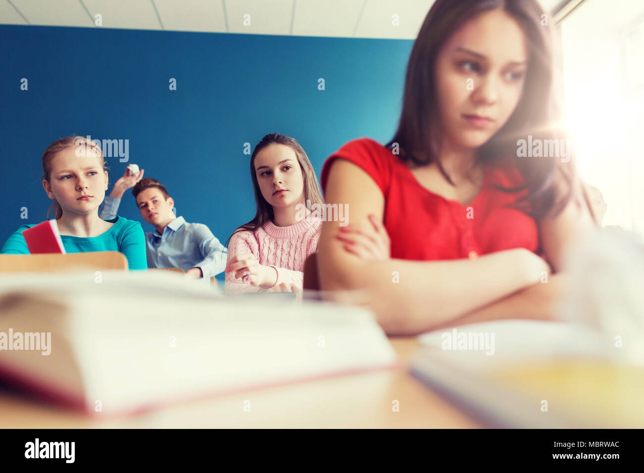 students gossiping behind classmate back at school Stock Photo - Alamy