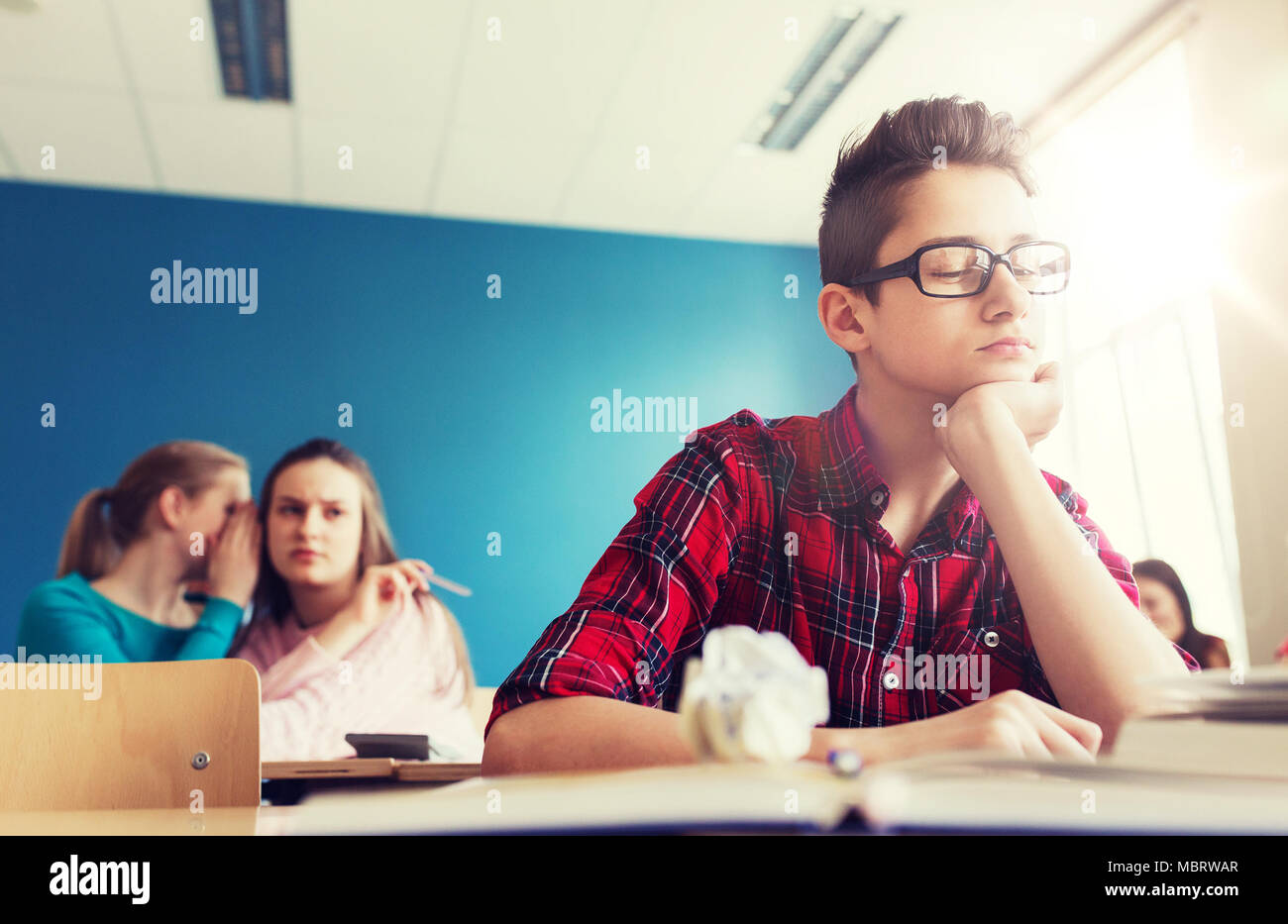 students gossiping behind classmate back at school Stock Photo - Alamy