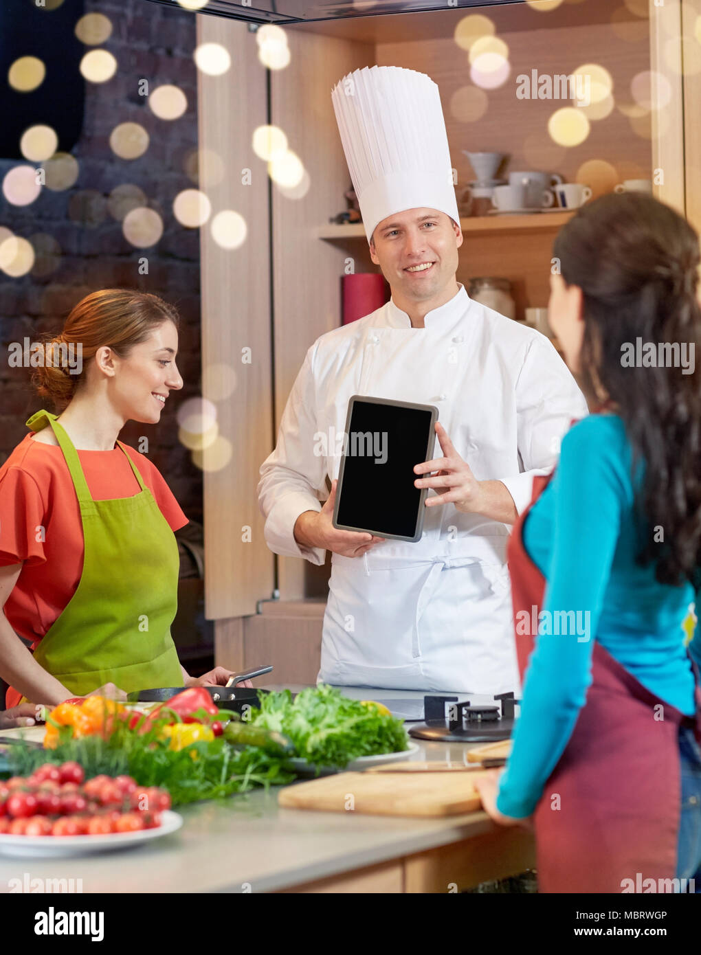happy women with chef and tablet pc in kitchen Stock Photo - Alamy