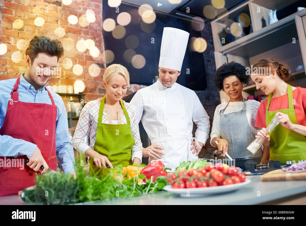 happy friends and chef cook cooking in kitchen Stock Photo - Alamy