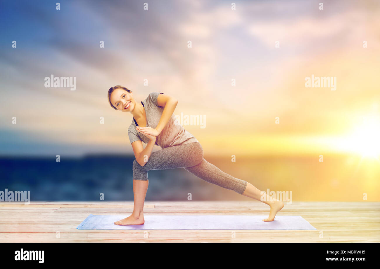 woman making yoga low angle lunge pose on mat Stock Photo - Alamy