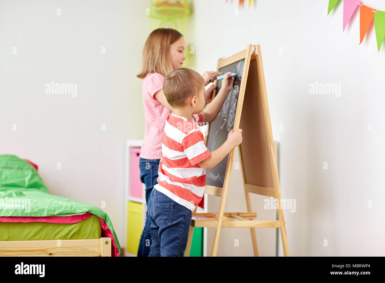 happy kids drawing on chalk board at home Stock Photo - Alamy