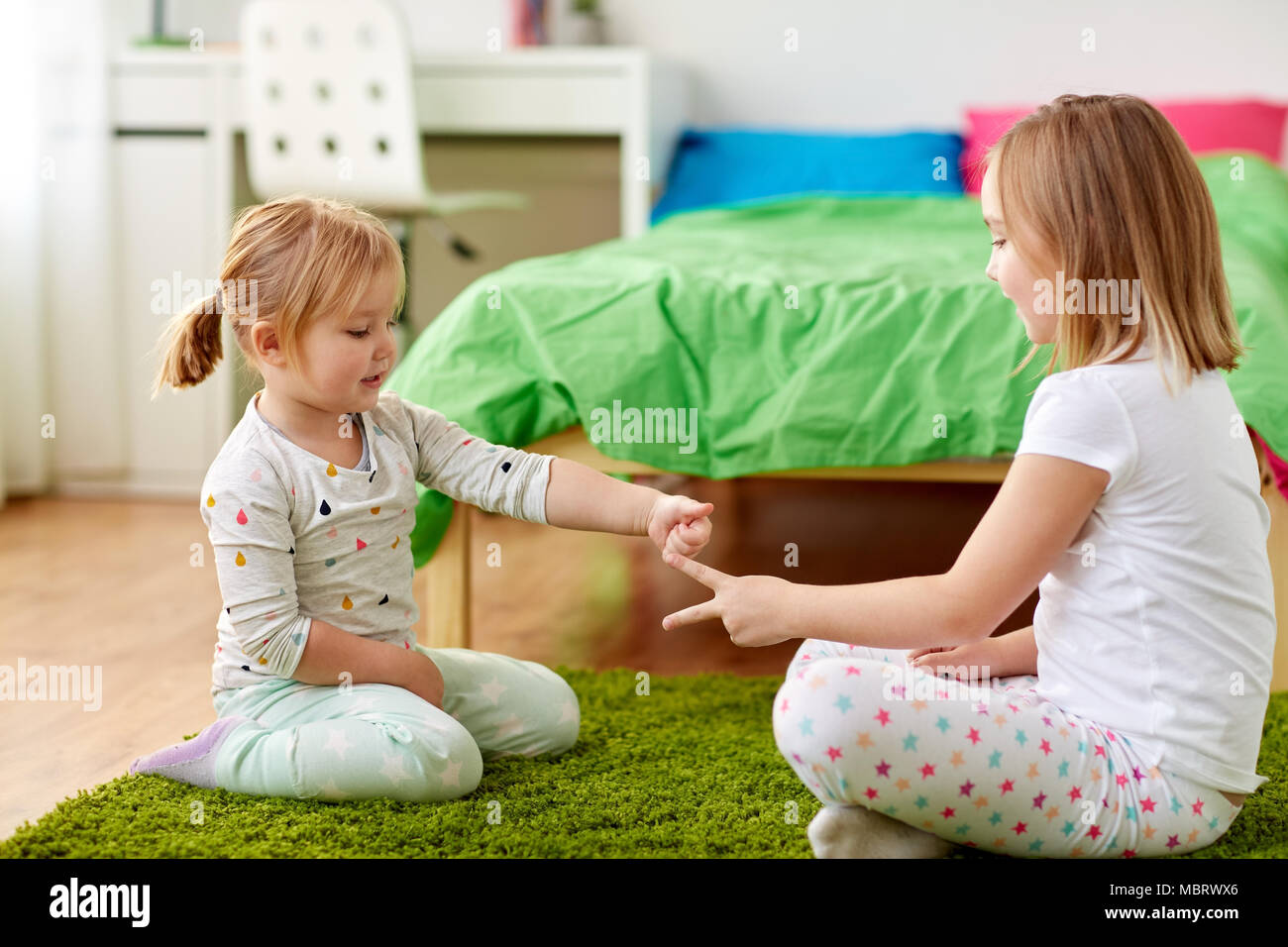 girls playing rock-paper-scissors game at home Stock Photo - Alamy