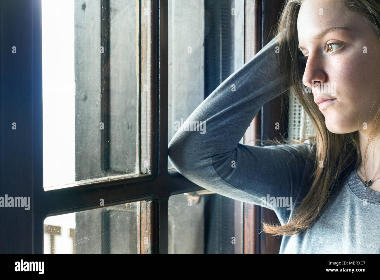 Girl looking through a window hi-res stock photography and images - Alamy
