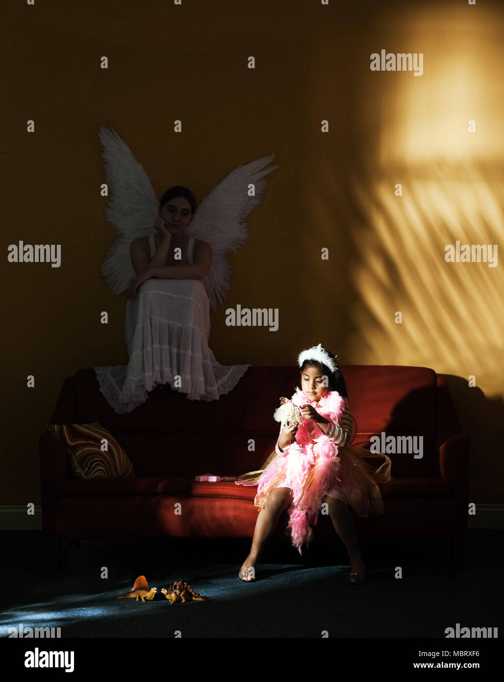 Guardian angel looking down on child playing Stock Photo - Alamy