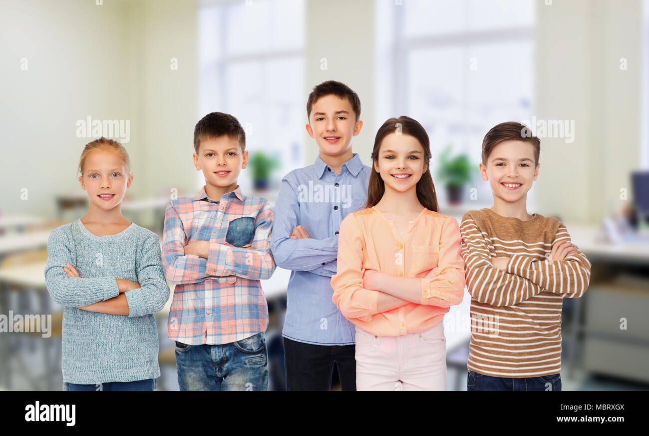 happy students at school over classroom background Stock Photo - Alamy