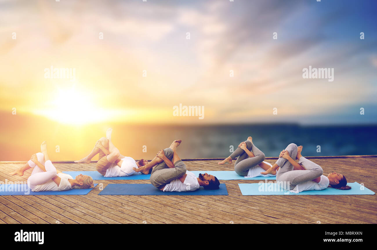 group of people doing yoga pose outdoors Stock Photo - Alamy