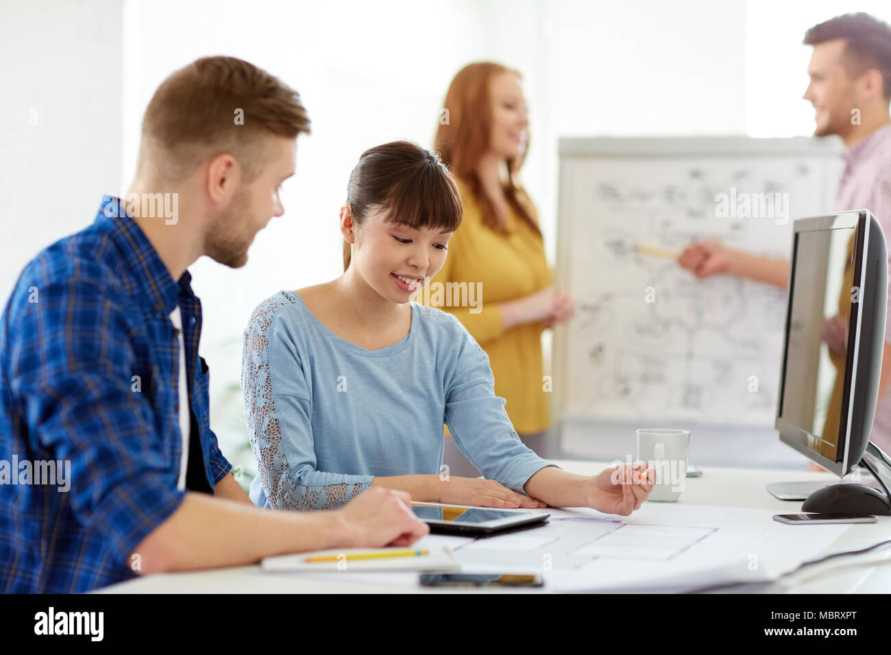 creative team with blueprint at office Stock Photo - Alamy