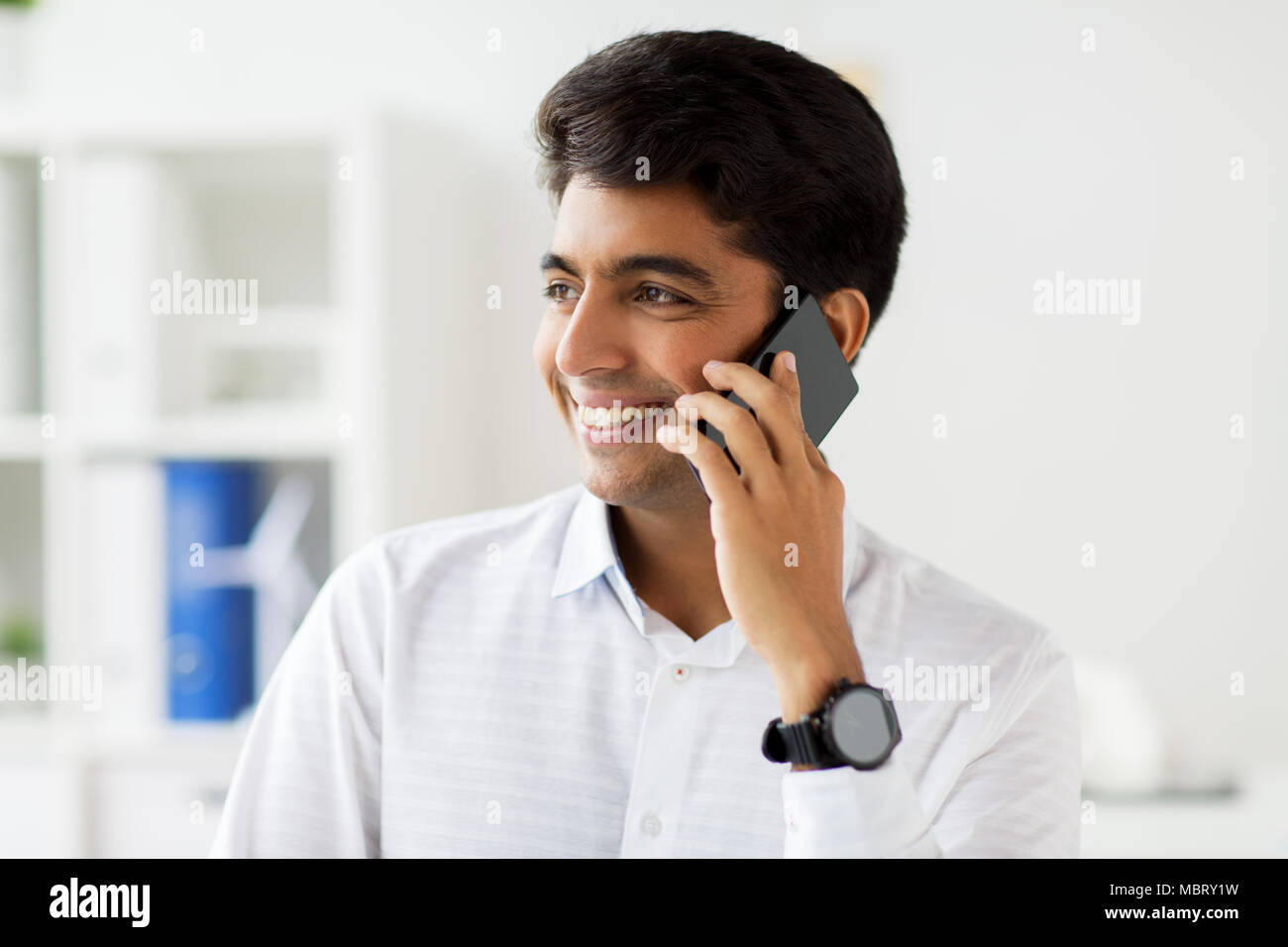 businessman calling on smartphone at office Stock Photo - Alamy