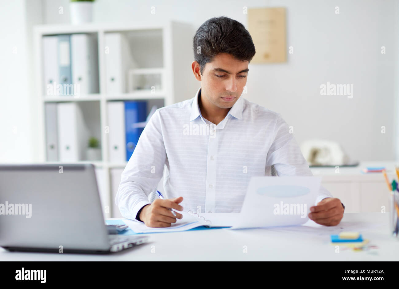 businessman working with papers at office Stock Photo - Alamy