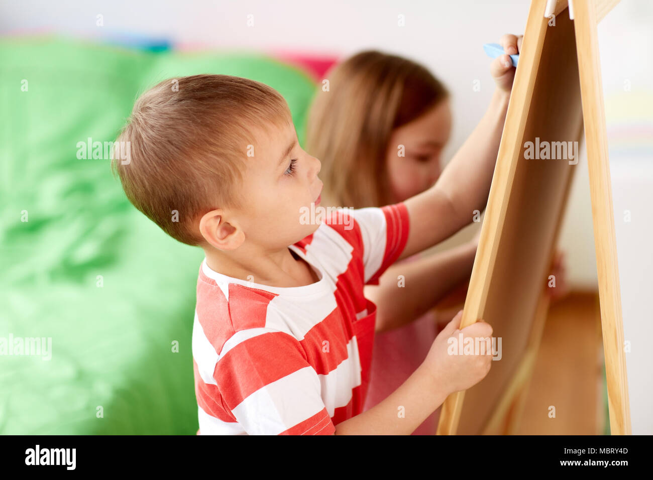 happy kids drawing on chalk board at home Stock Photo - Alamy