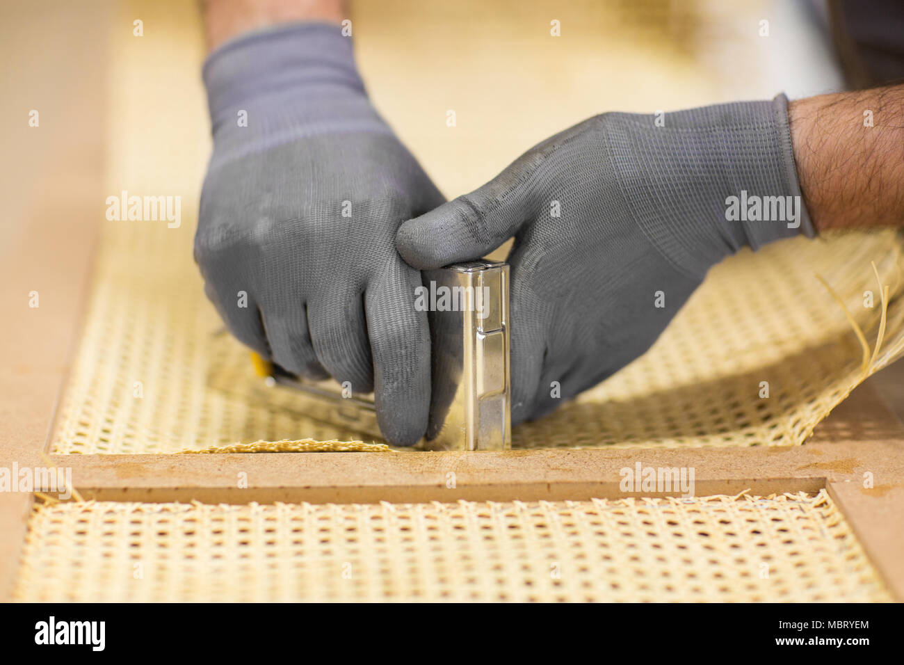 assembler with staple gun making furniture Stock Photo - Alamy