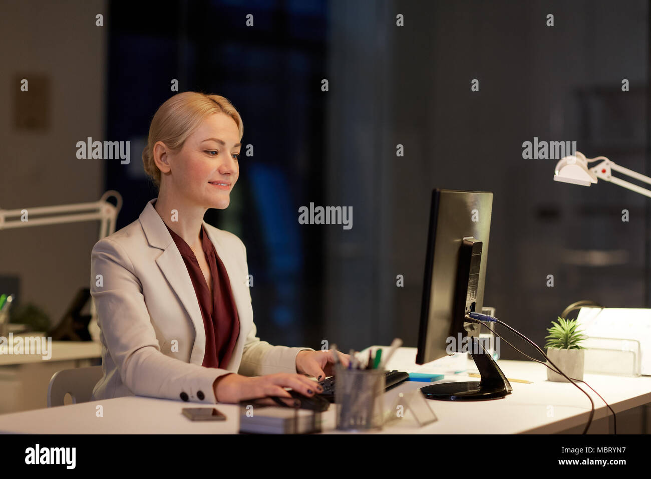 businesswoman at computer working at night office Stock Photo - Alamy