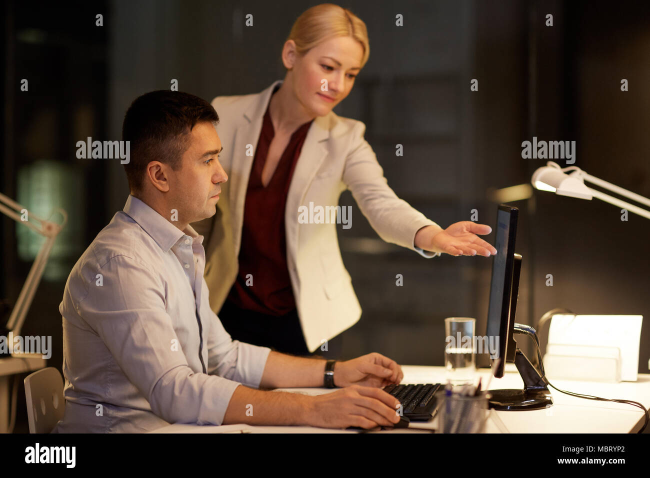 business team with computer working late at office Stock Photo - Alamy