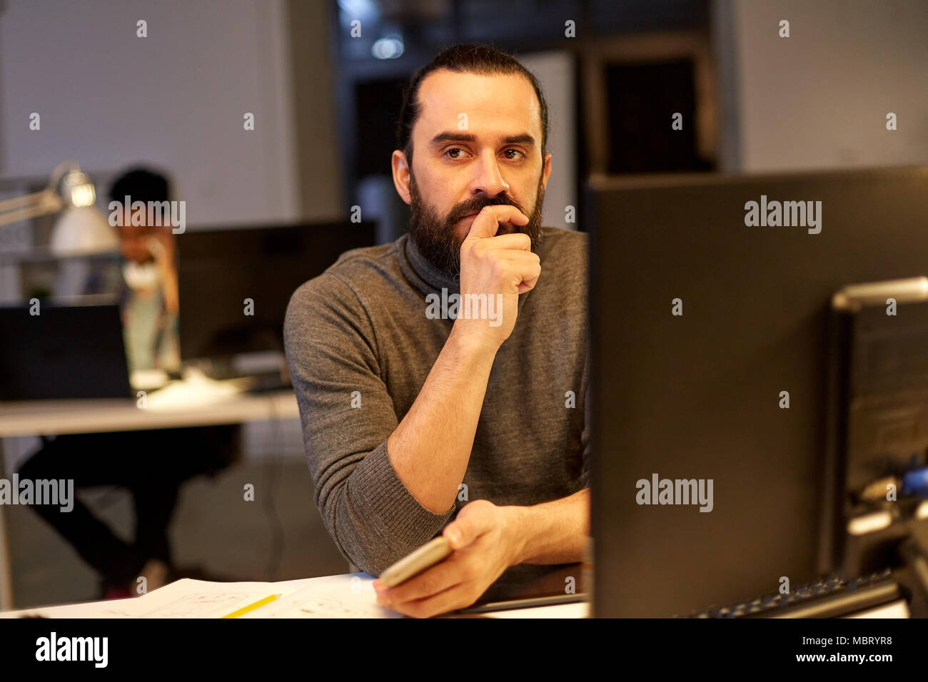 creative man with computer working at night office Stock Photo - Alamy