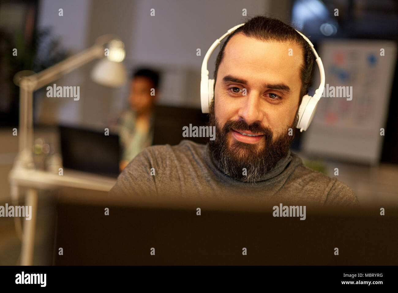 creative man with headphones working at office Stock Photo - Alamy